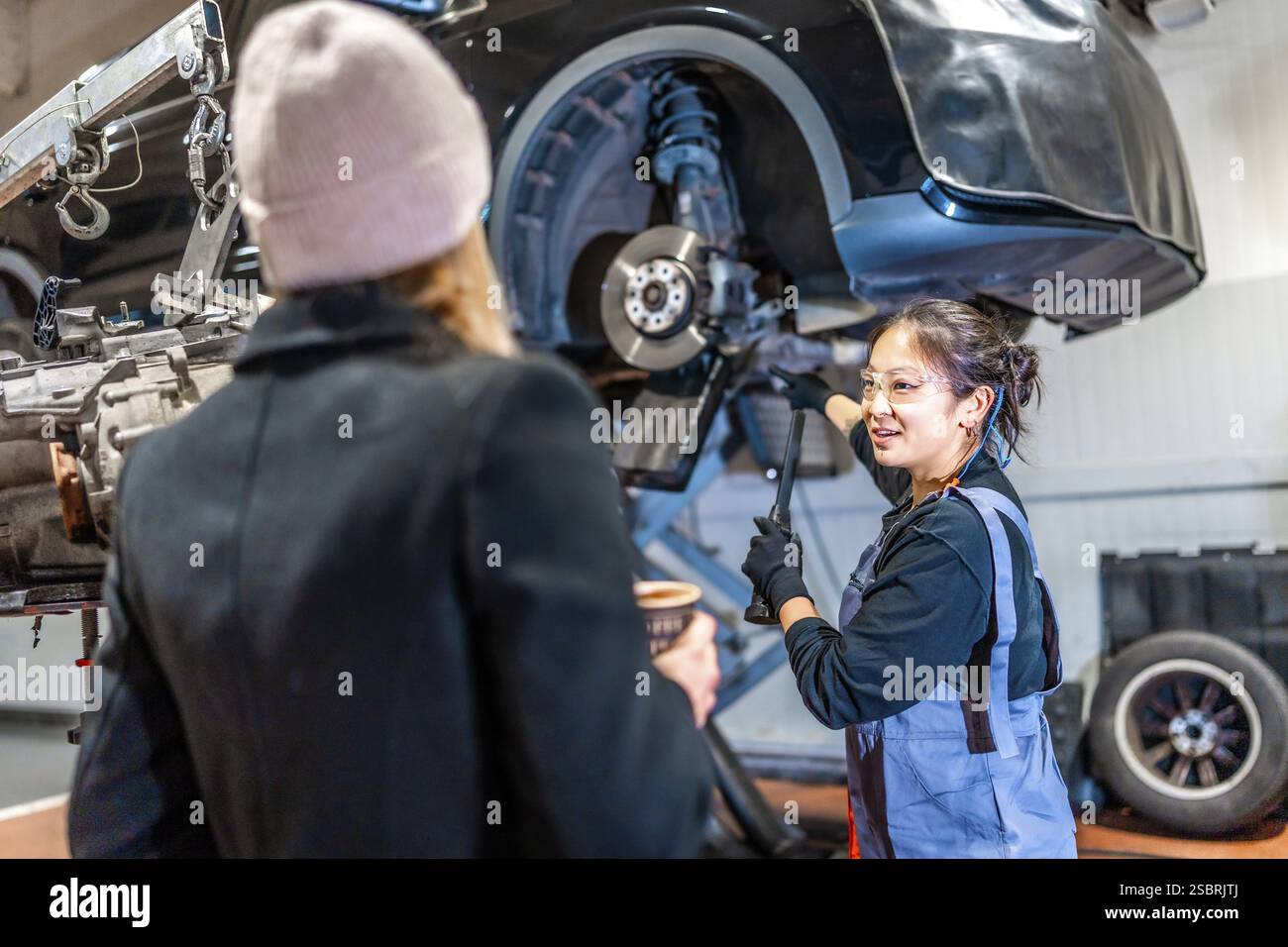 Skilled mechanic discussing vehicle maintenance with a customer ...