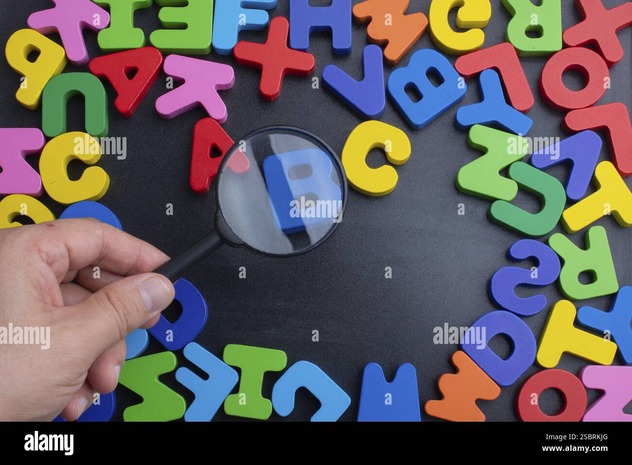 Magnifying glass and Colorful Letters of Alphabet Stock Photo - Alamy