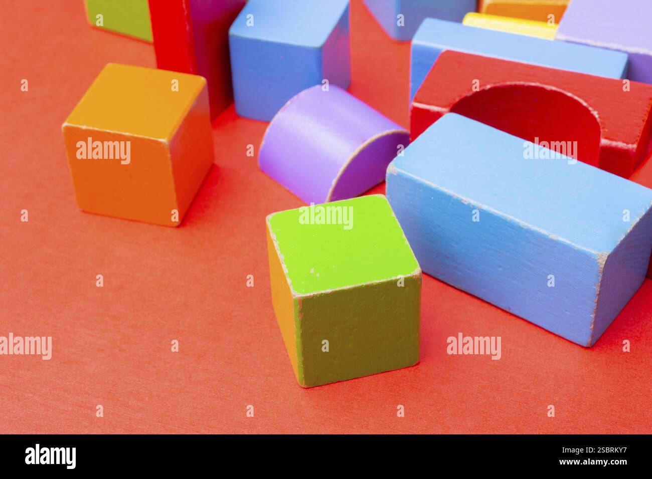Different color and shape wooden toy building blocks Stock Photo - Alamy