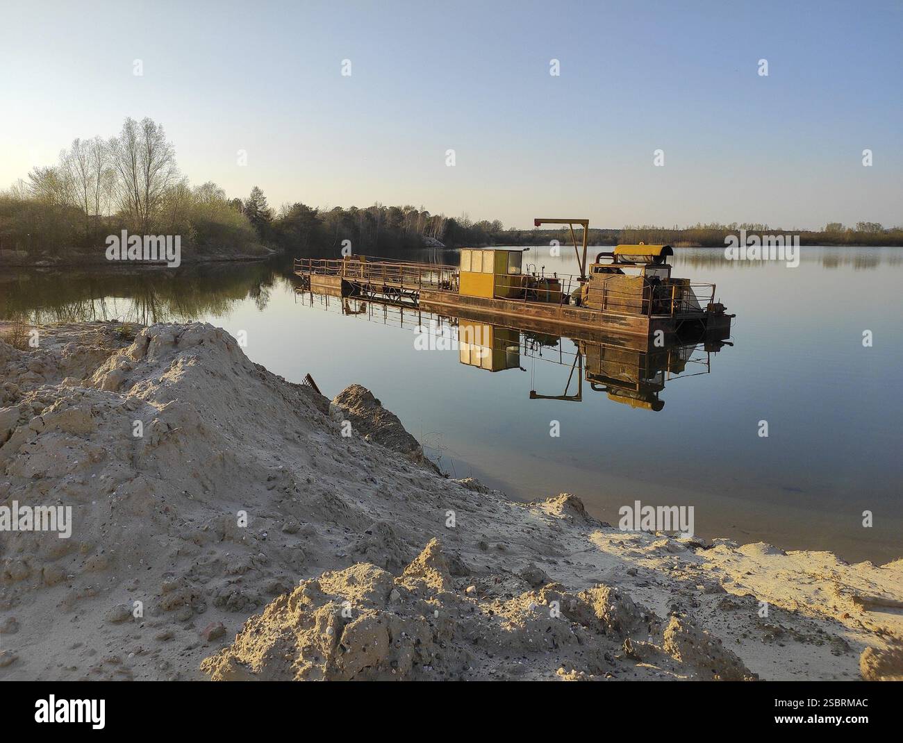 Excavation machine at earthmoving work in sand quarry. Extraction of ...