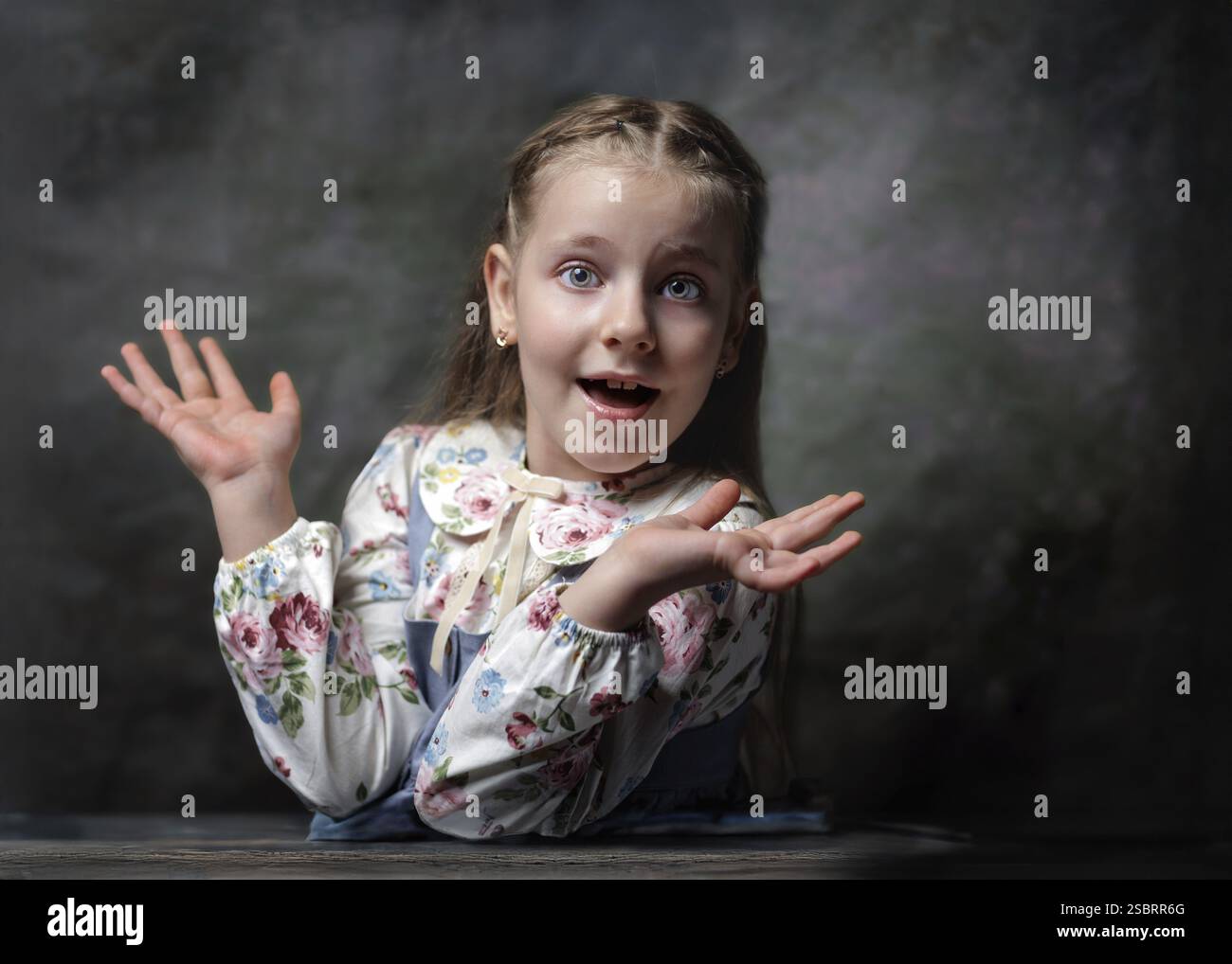 Photographs of a girl in a floral dress on a dark background ...