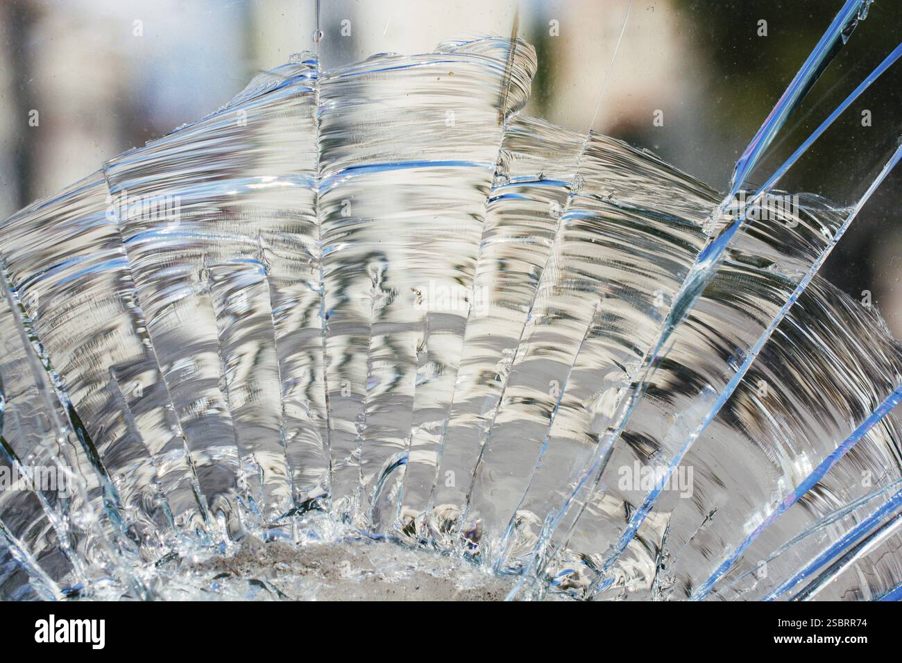 Damaged glass with a hole in shatters into small pieces Stock Photo - Alamy
