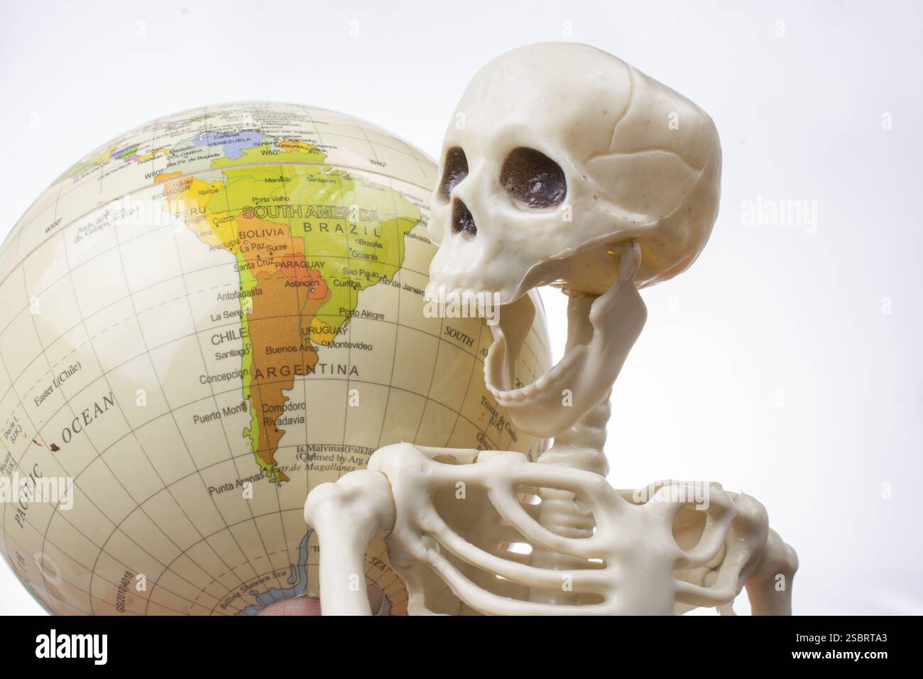 The earth in a skeleton hand Stock Photo - Alamy