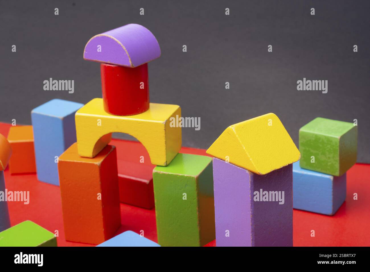 Different color and shape wooden toy building blocks Stock Photo - Alamy