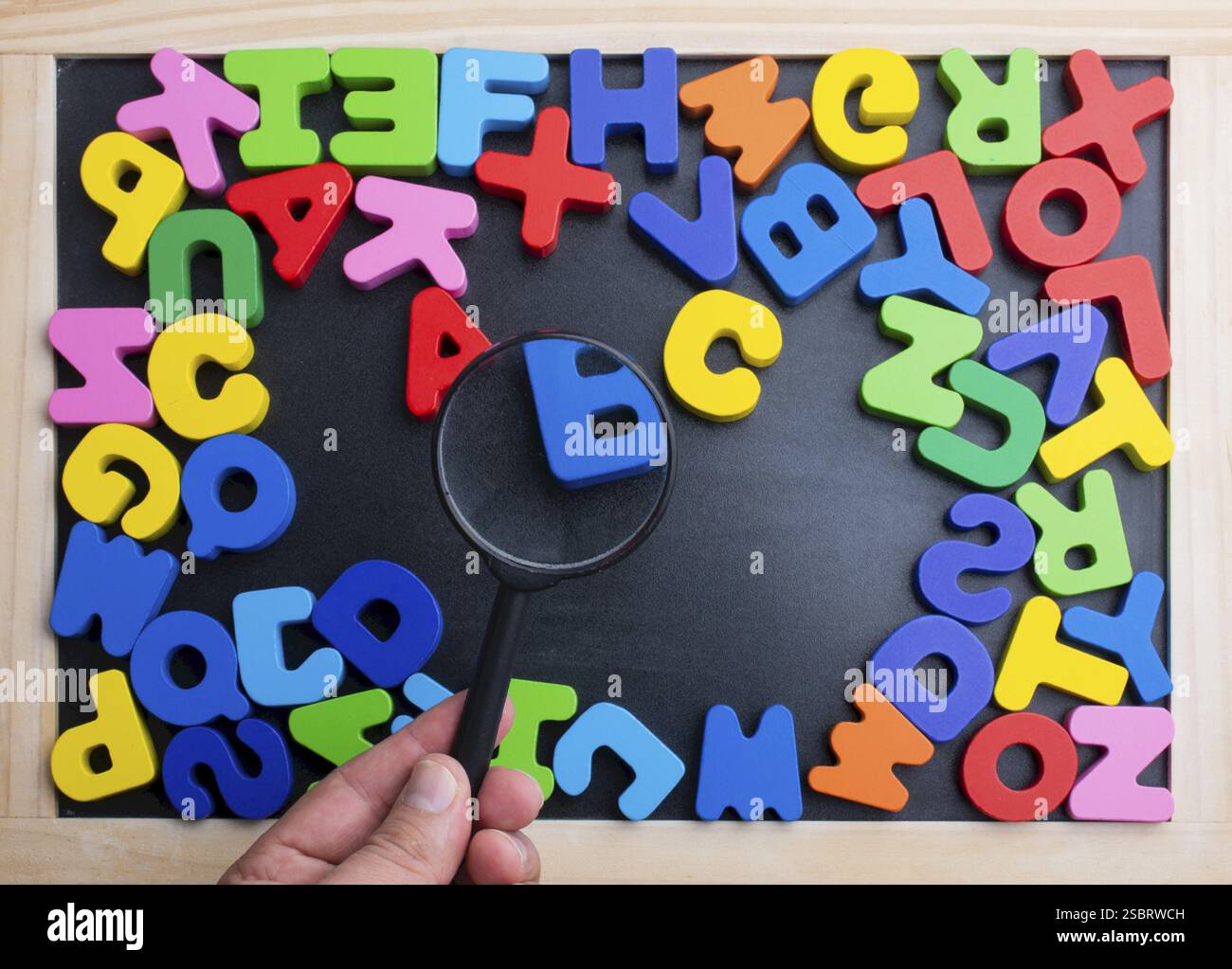 Colored wooden letters of the English alphabet on a white background ...