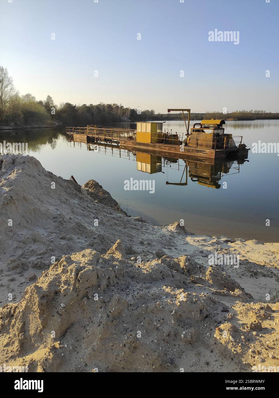 Excavation machine at earthmoving work in sand quarry. Extraction of ...