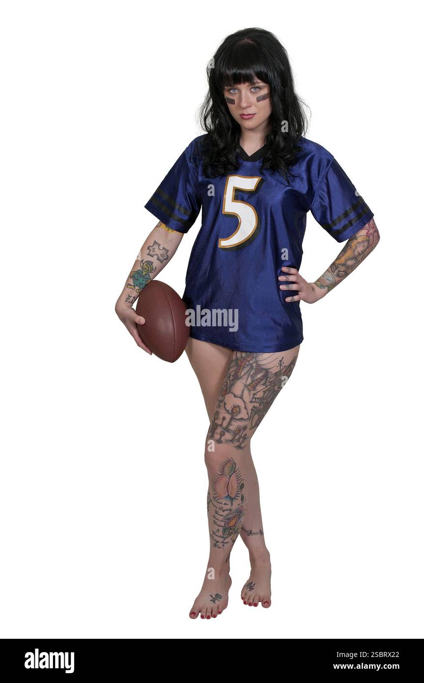Beautiful young woman playing a game of football Stock Photo - Alamy
