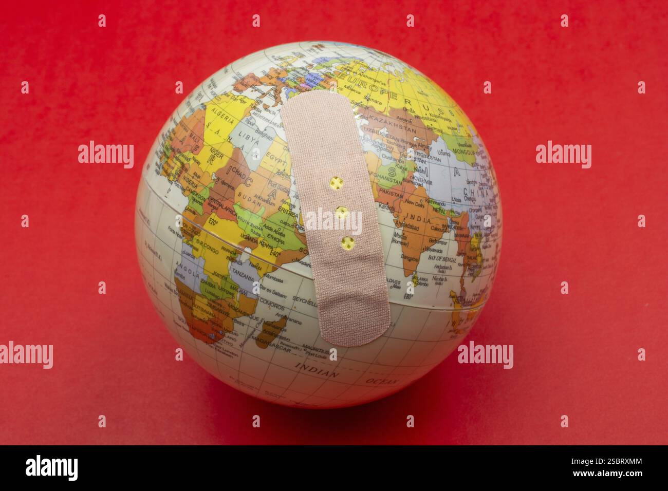 Earth with bandaid Solidarity and aid to countries in need concept ...