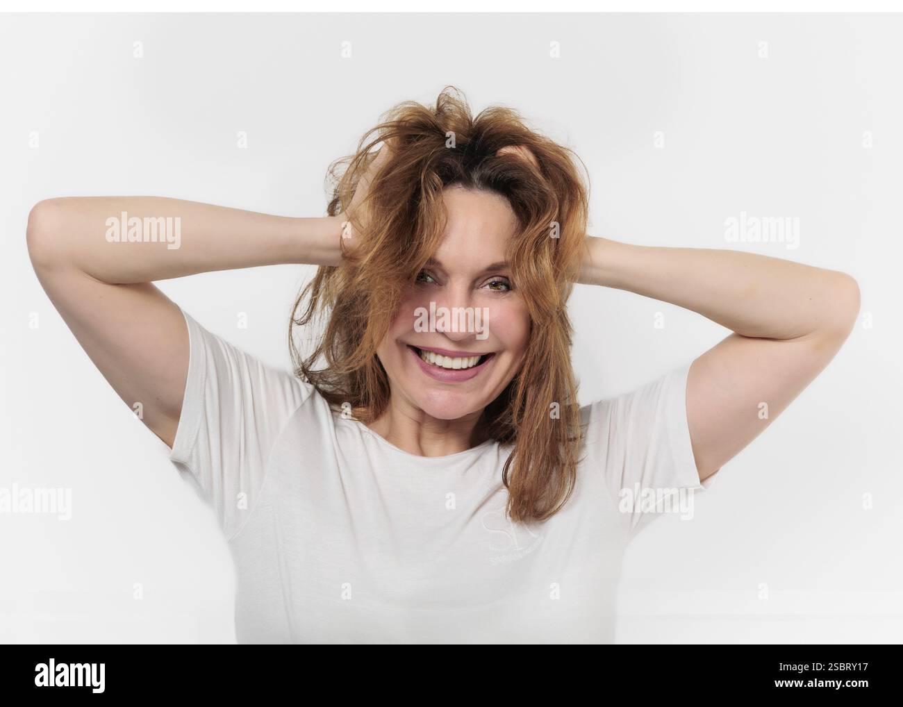 Happy mature woman laughing standing isolated on white background ...