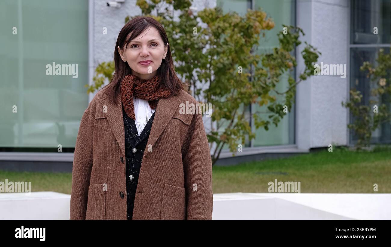 A senior woman with a thoughtful expression, representing natural aging ...