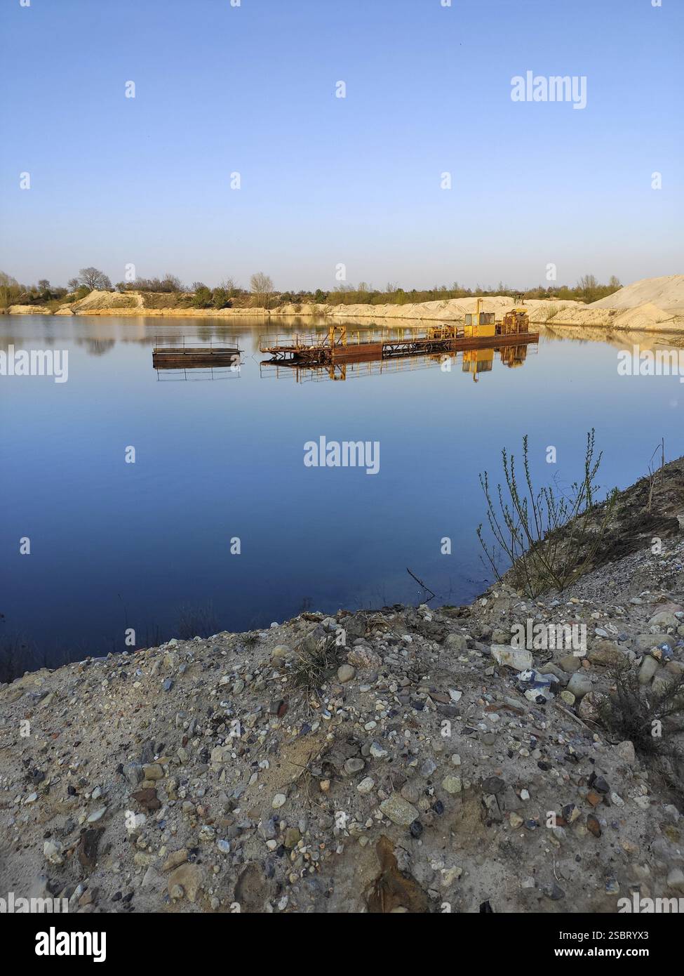 Excavation machine at earthmoving work in sand quarry. Extraction of ...