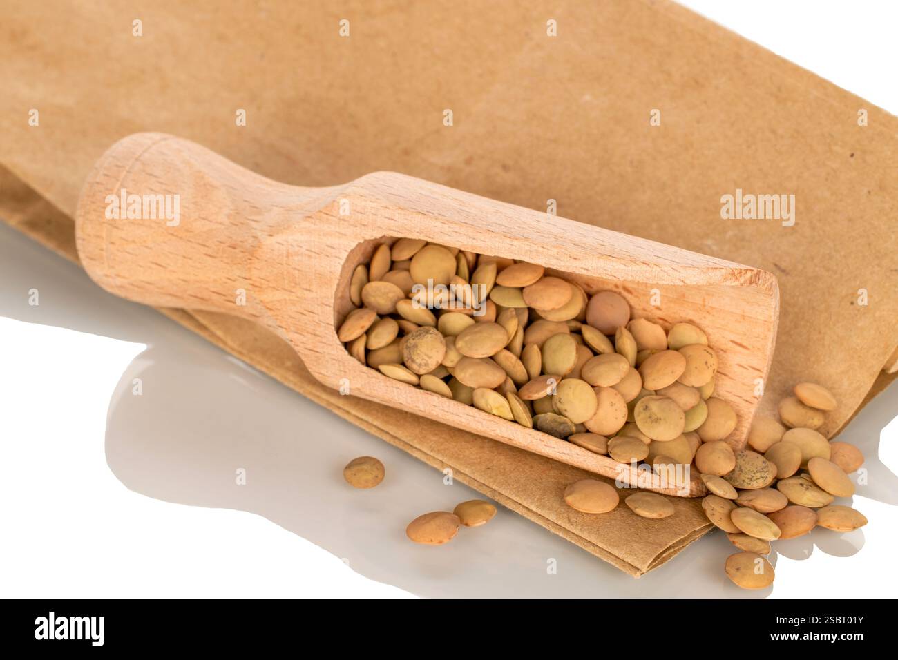 Raw lentils with wooden spoon and paper bag, isolated on white background, macro Stock Photo - Alamy