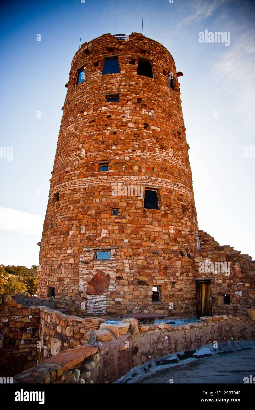 A tall brick tower with a door on the bottom. The tower is brown and ...