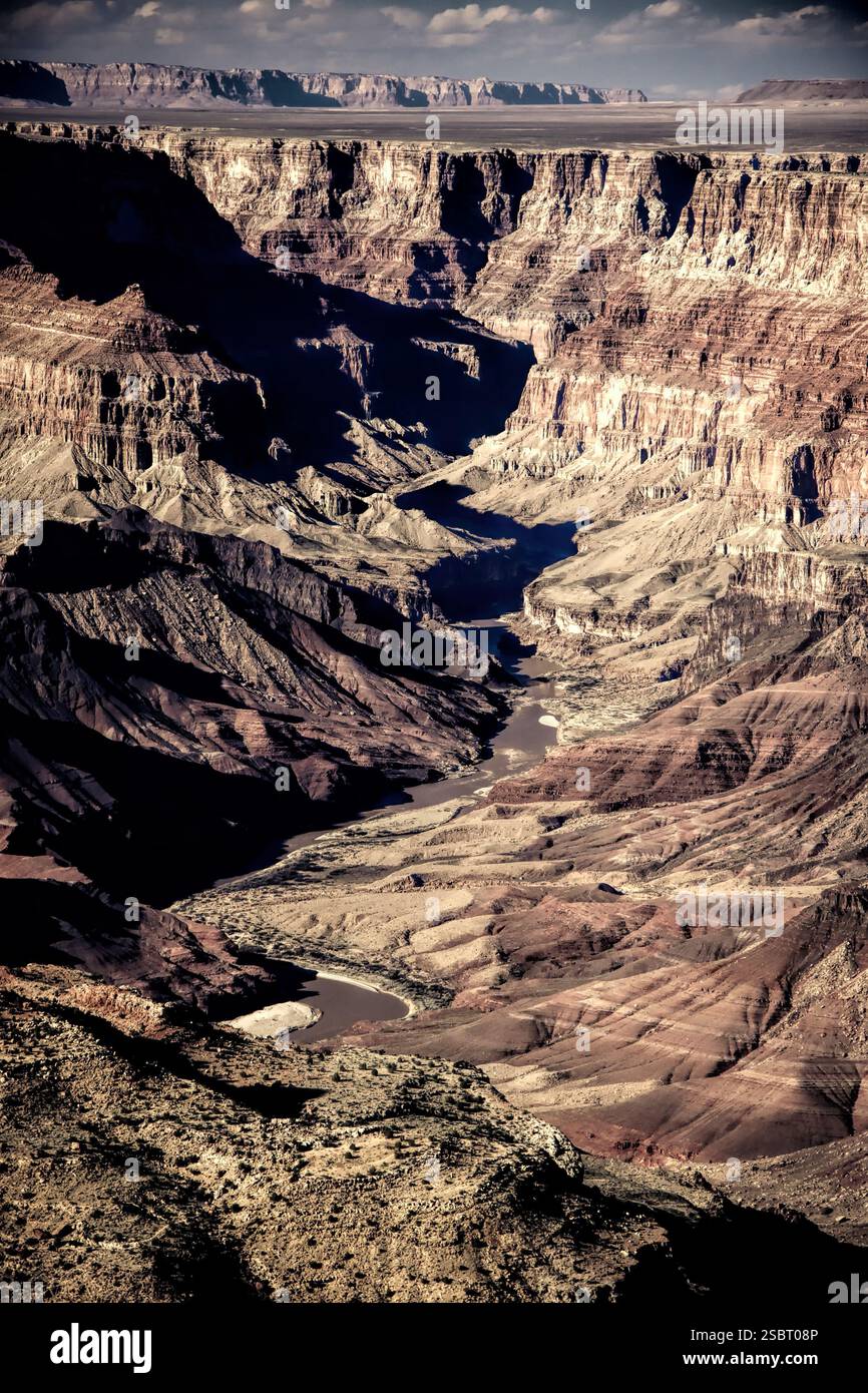 A canyon with a river running through it. The canyon is very deep and ...