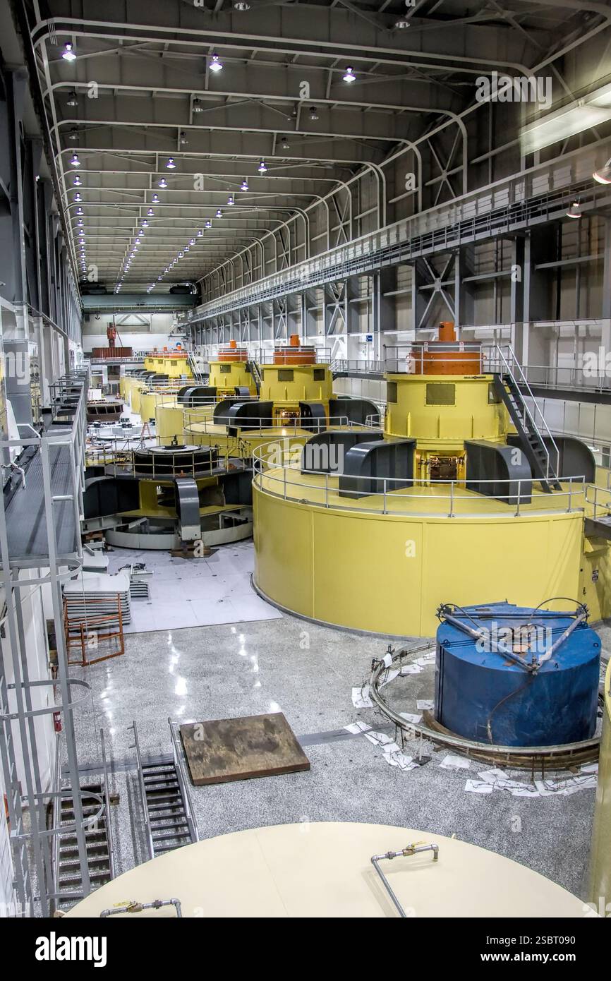 A large yellow building with a blue tank in the middle. There are ...