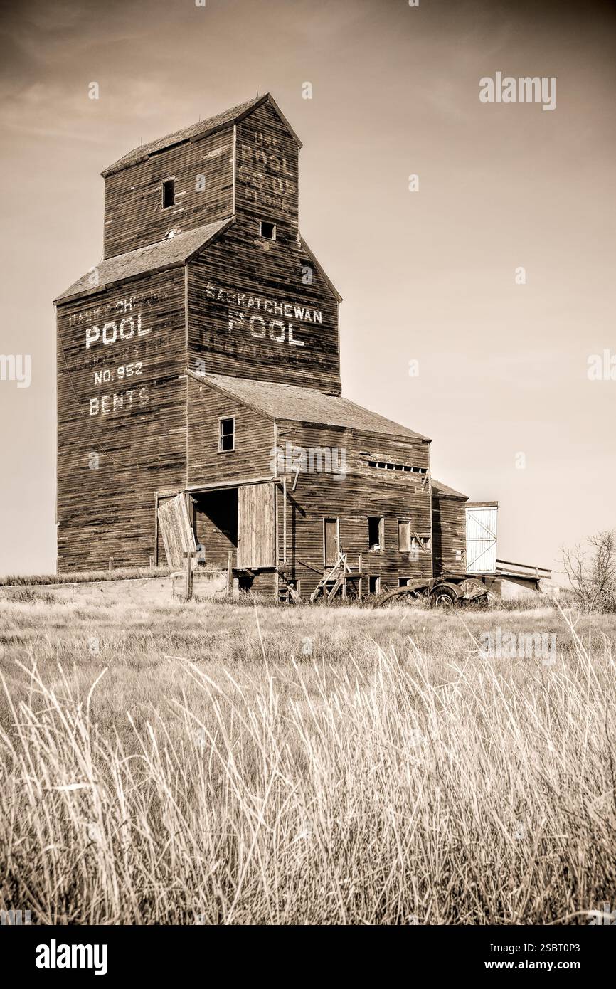 A grain silo with the words POOL on it. The silo is old and abandoned ...