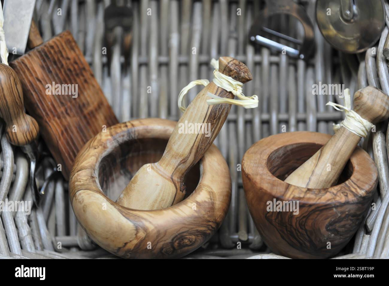 Wooden mortar and pestle in a basket, kitchen tools in traditional ...