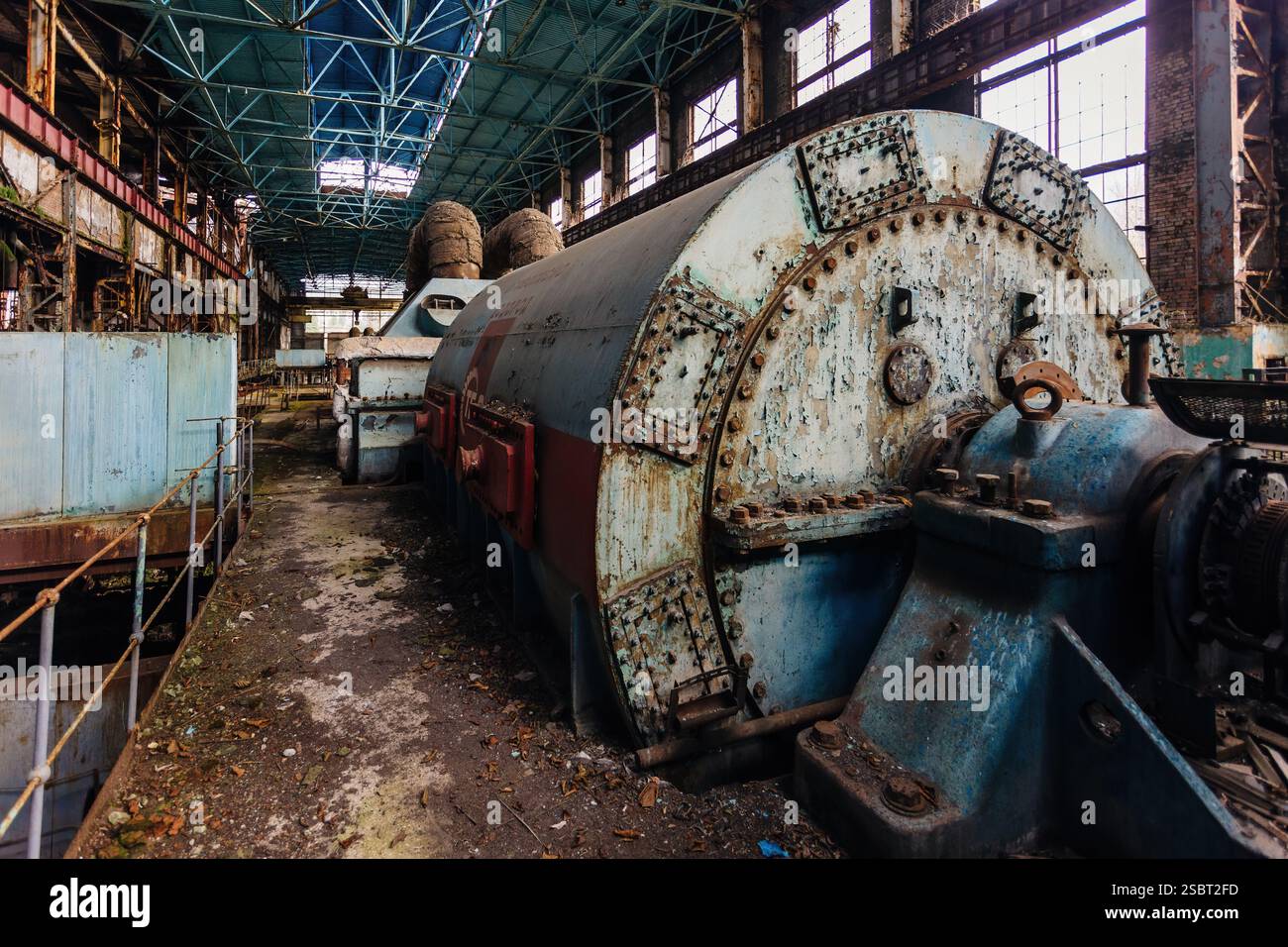 Rusty turbine generator. Abandoned destroyed by war and overgrown by ...