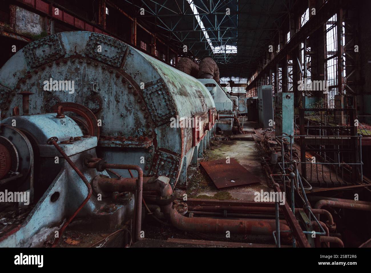 Rusty turbine generator. Abandoned destroyed by war and overgrown by ...