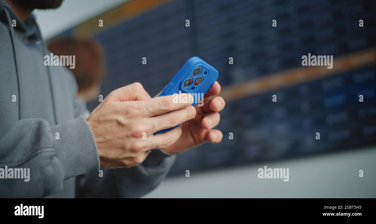 International Airport Terminal: Man Using Smartphone to Check ...