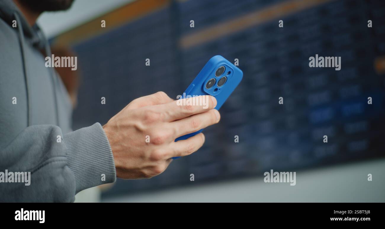 International Airport Terminal: Man Using Smartphone to Check ...