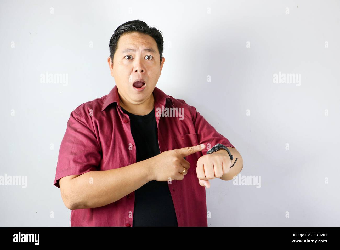 Shocked expression of A man pointing his finger into his watch avoid ...