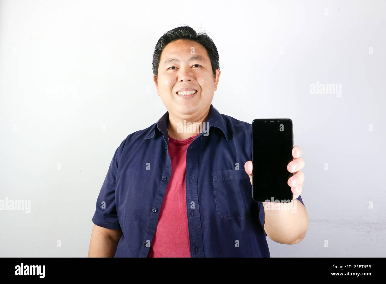 Cheerful Man Showing Smartphone facing to camera Stock Photo - Alamy