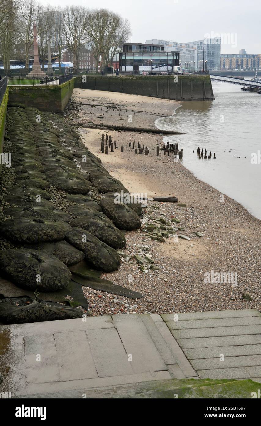 Ancient wooden jetty posts on the edge of The River Thames at Greenwich ...