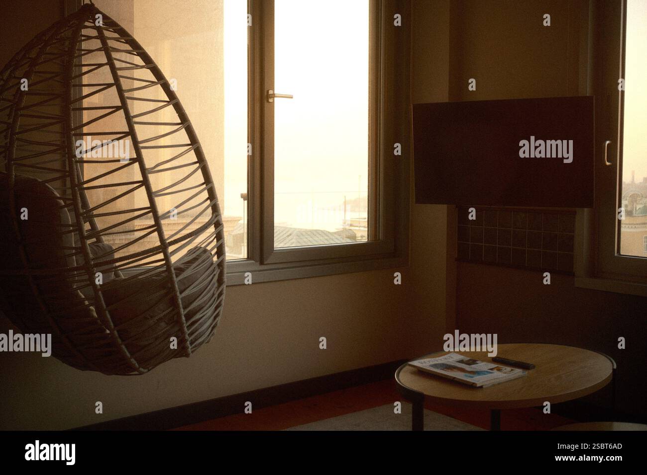 Cozy corner in a modern apartment interior with a hanging swing chair ...