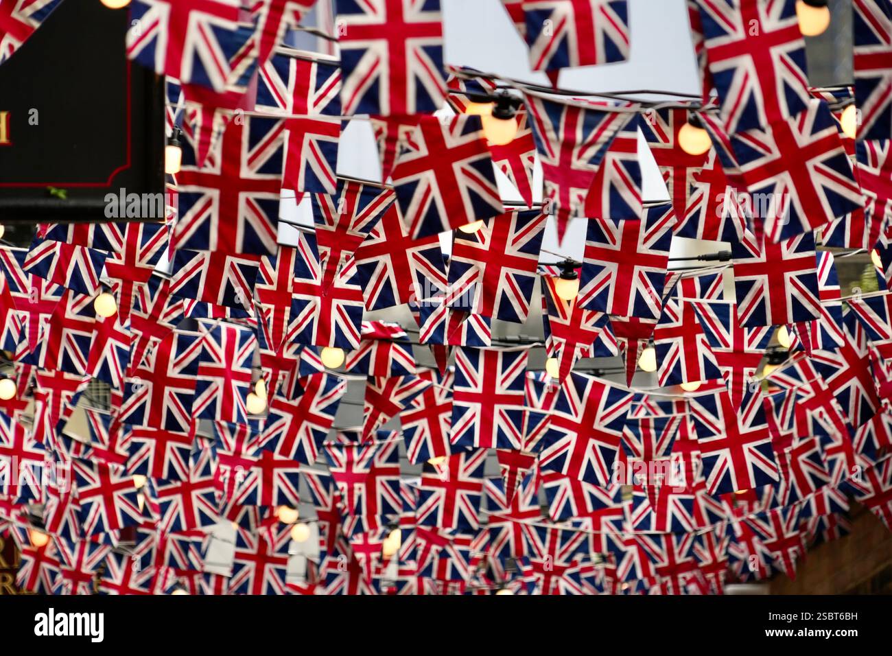 Multiple Union Jack flags hanging overhead Stock Photo - Alamy
