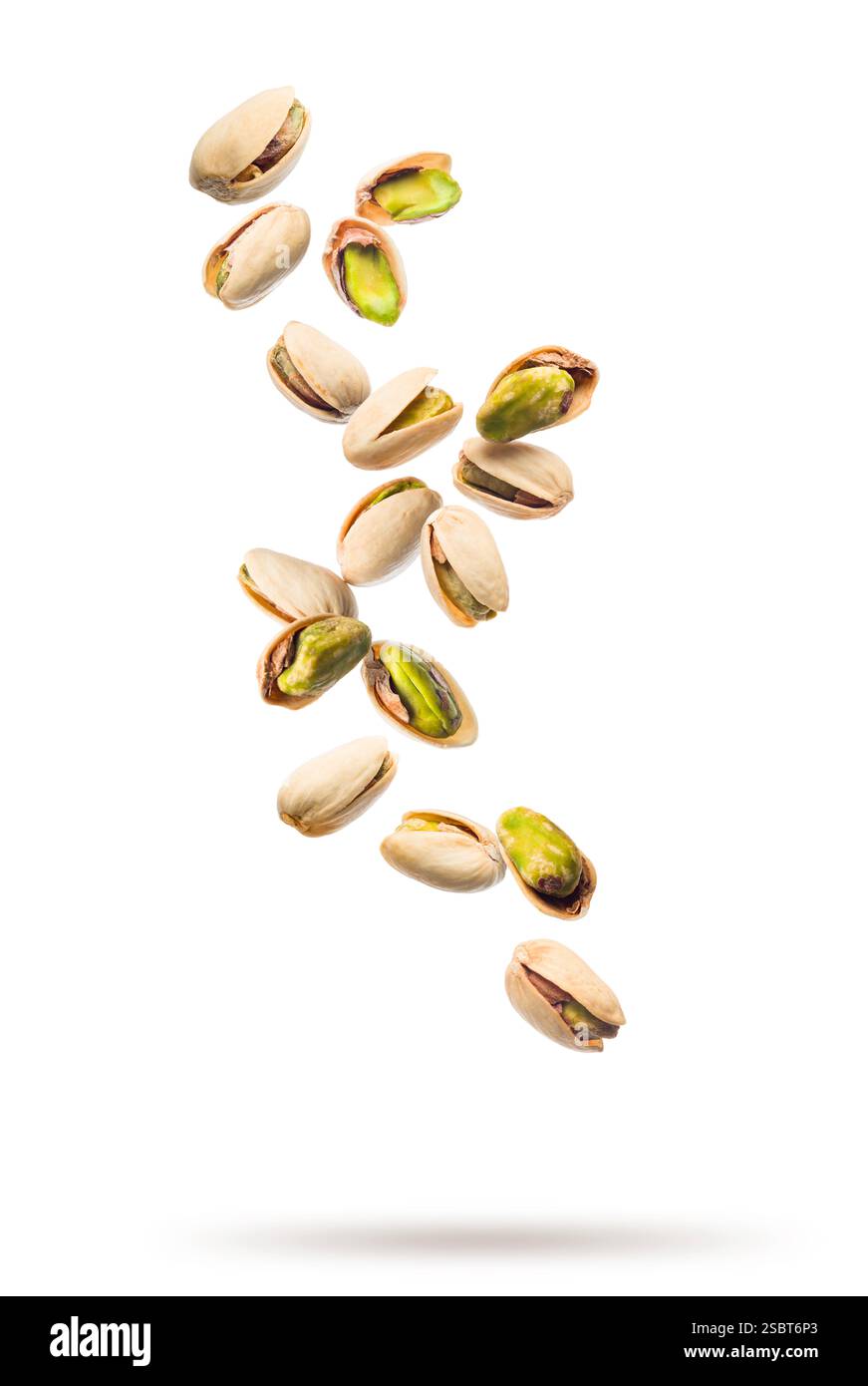 Pistachio nuts flying isolated on white background Stock Photo - Alamy
