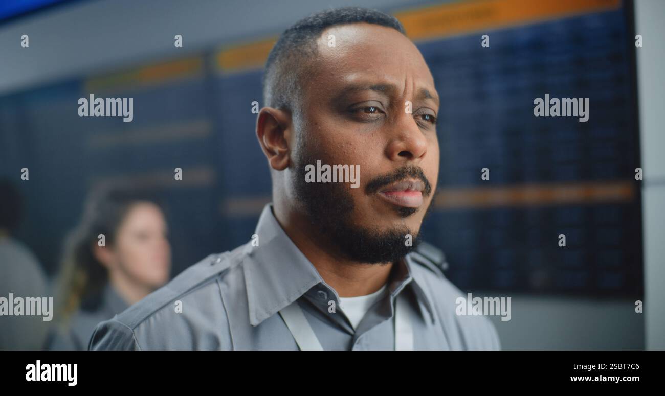 Portrait of African American Security Officer Smiling, Looking at ...