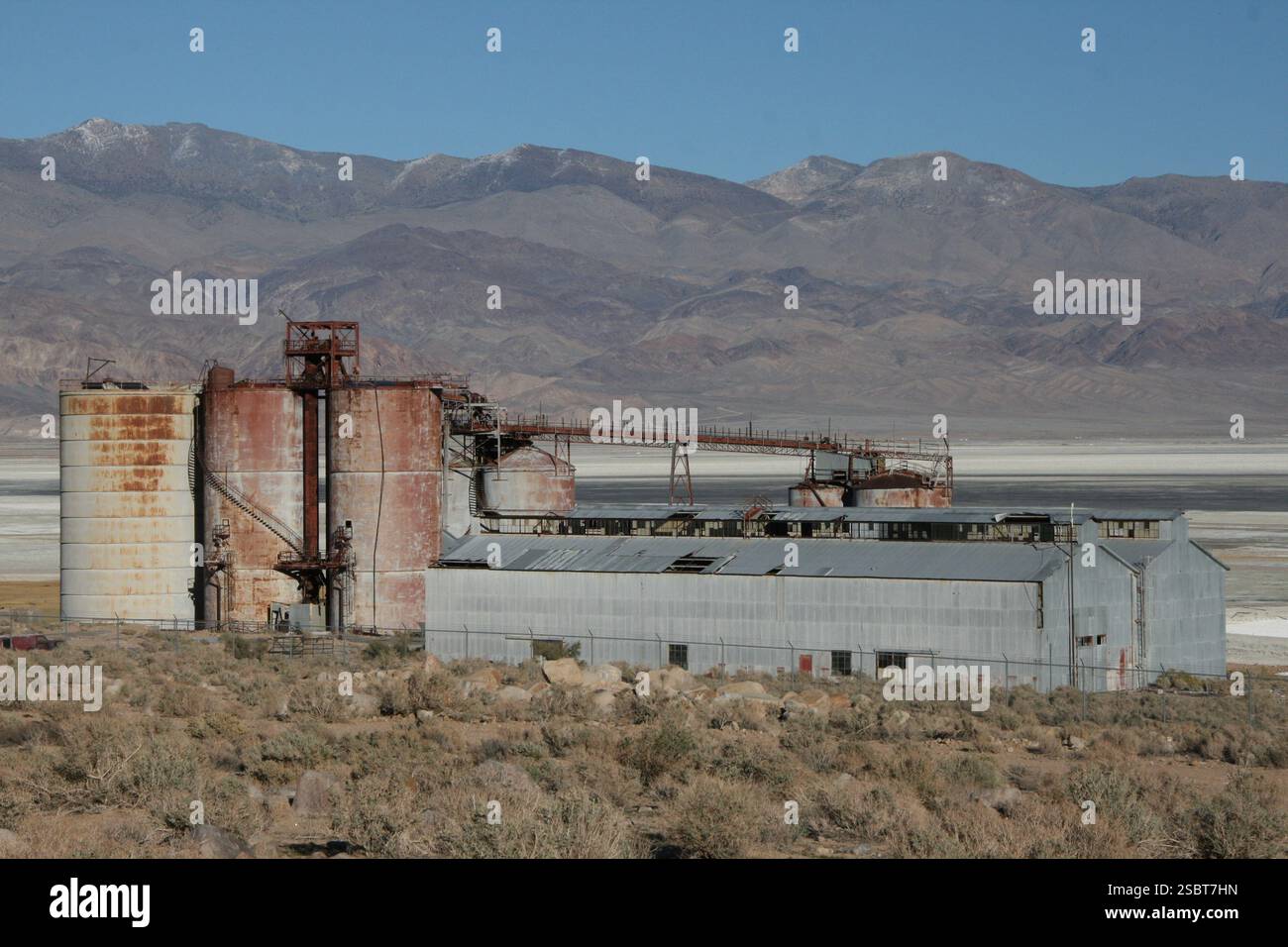 An abandoned mid-century factory on the Owens dry lake in the desert ...