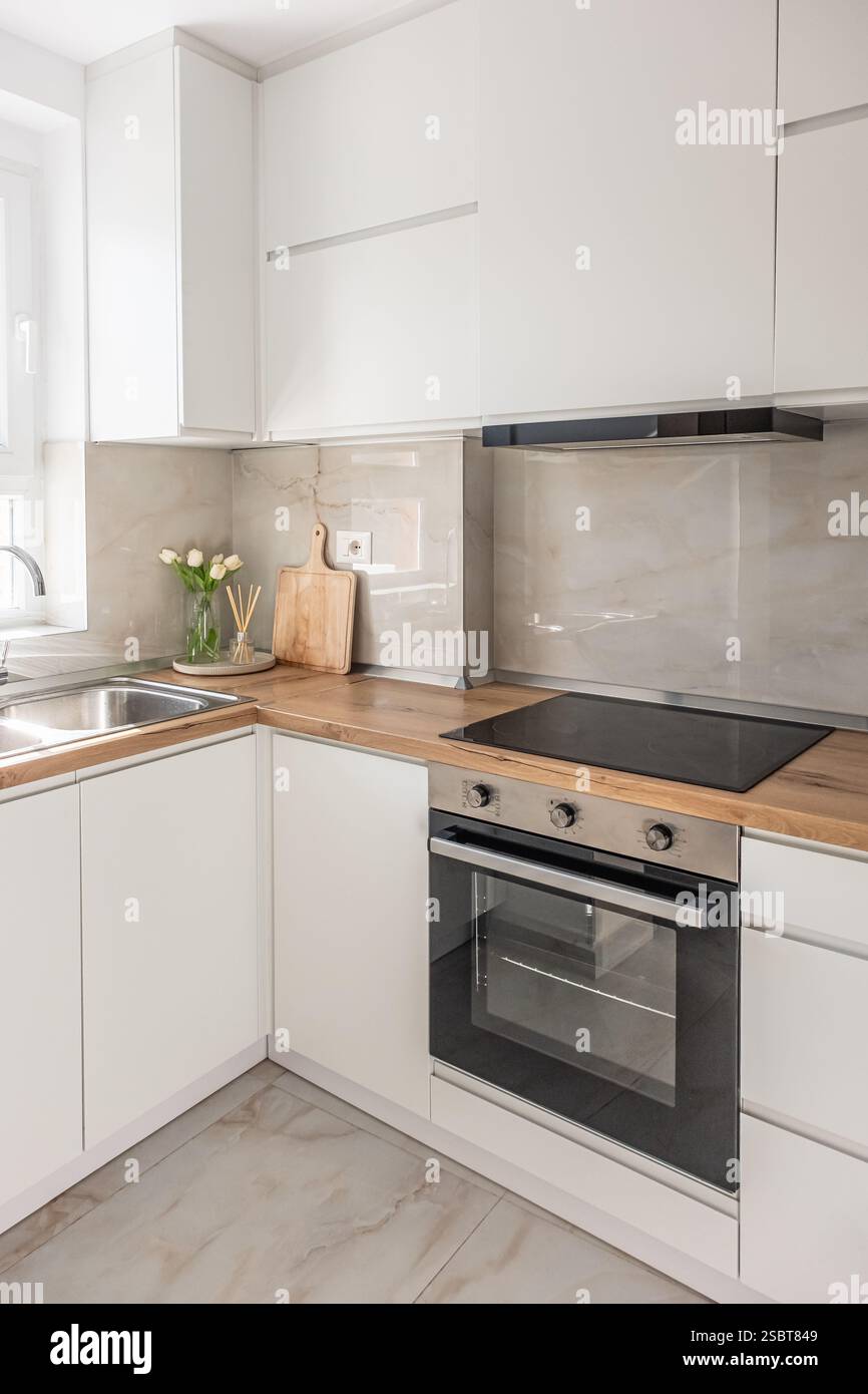 A kitchen interior with wooden countertop and cooking stove. Counter ...