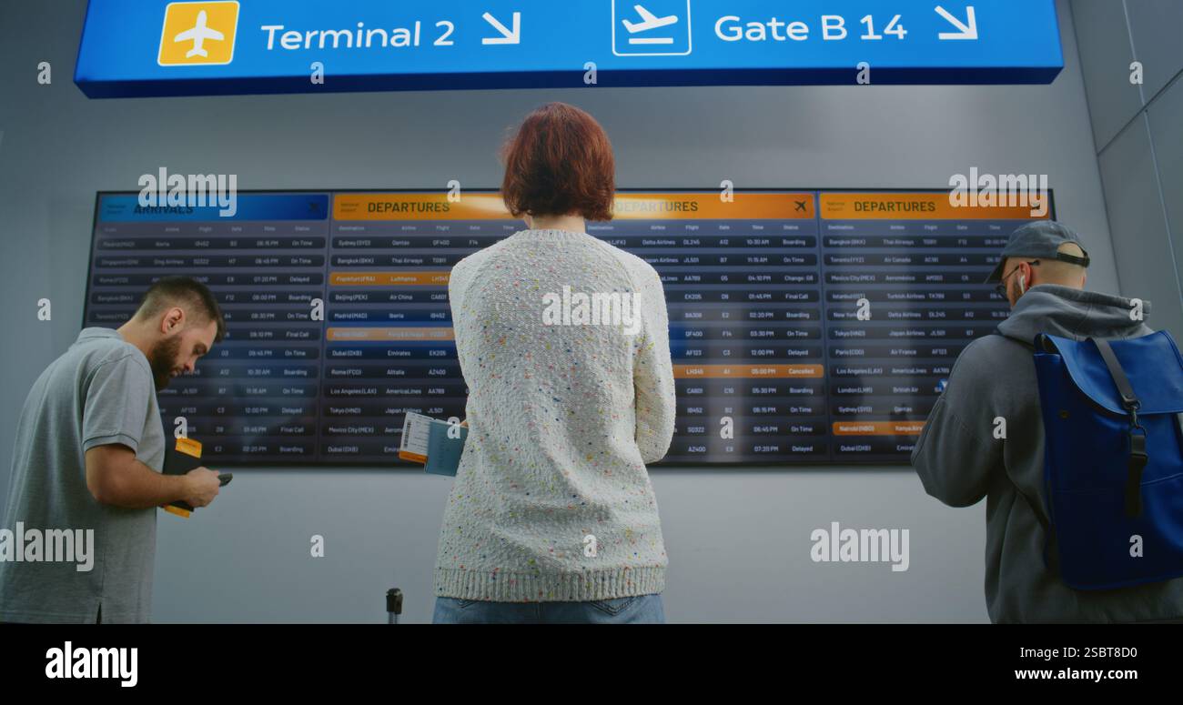Passengers with Baggage and Tickets Checking Departures on Flight ...