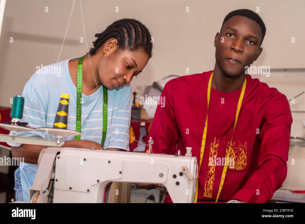 Young female trainee African-American ethnicity, learning craft from a ...