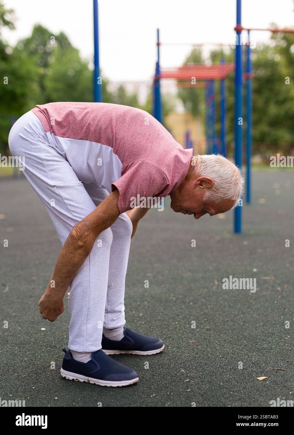 Old man warming up before training outdoors Stock Photo - Alamy