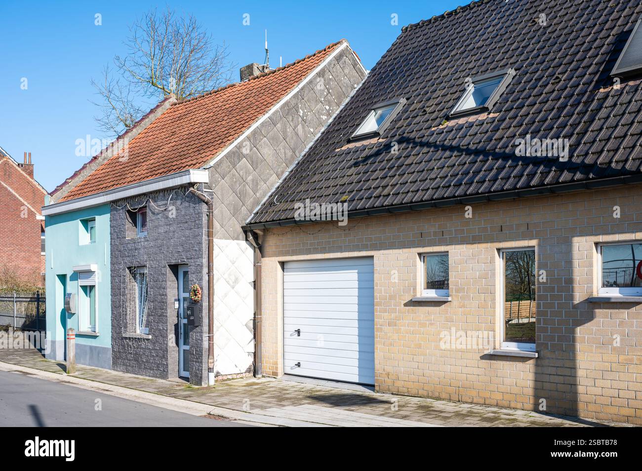 Facades of regular houses in a row at the Flemish countryside in Asse ...
