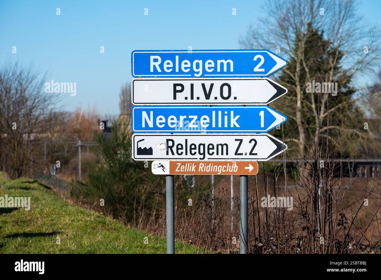 Blue direction sign to Relegem, PIVO and the Zellik Riging club in ...