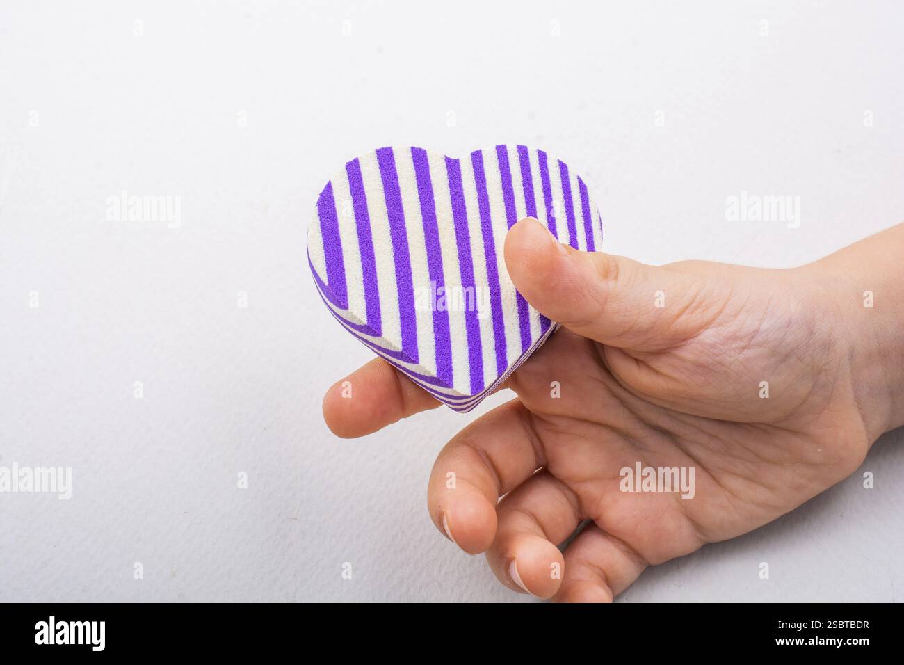 Heart shaped object in hand as love conception Stock Photo - Alamy