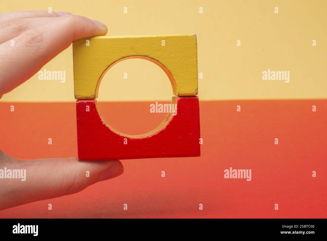Hand building tower with colorful building blocks Stock Photo - Alamy