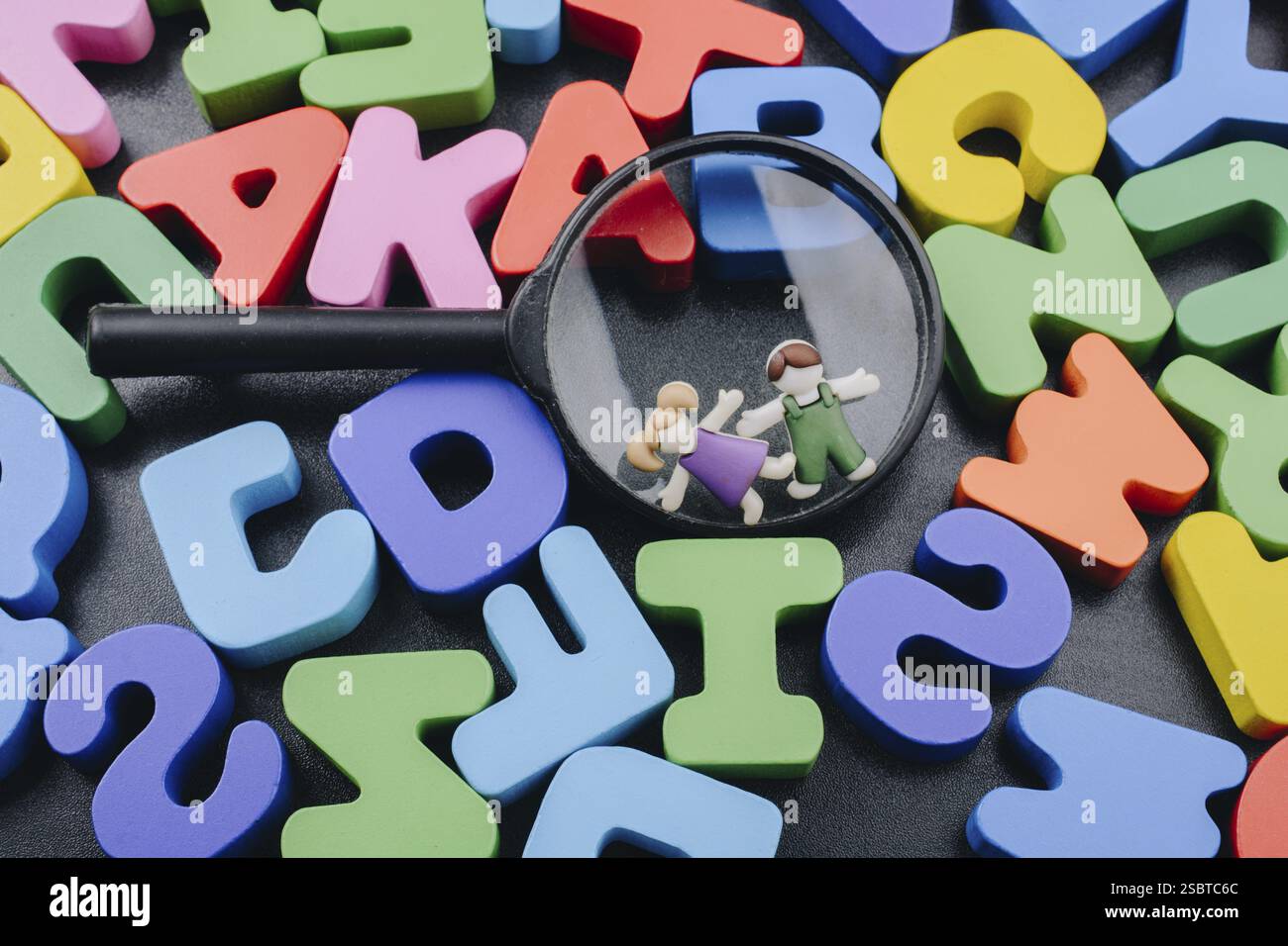 Kids over Magnifying glass and Colorful Letters of Alphabet Stock Photo ...