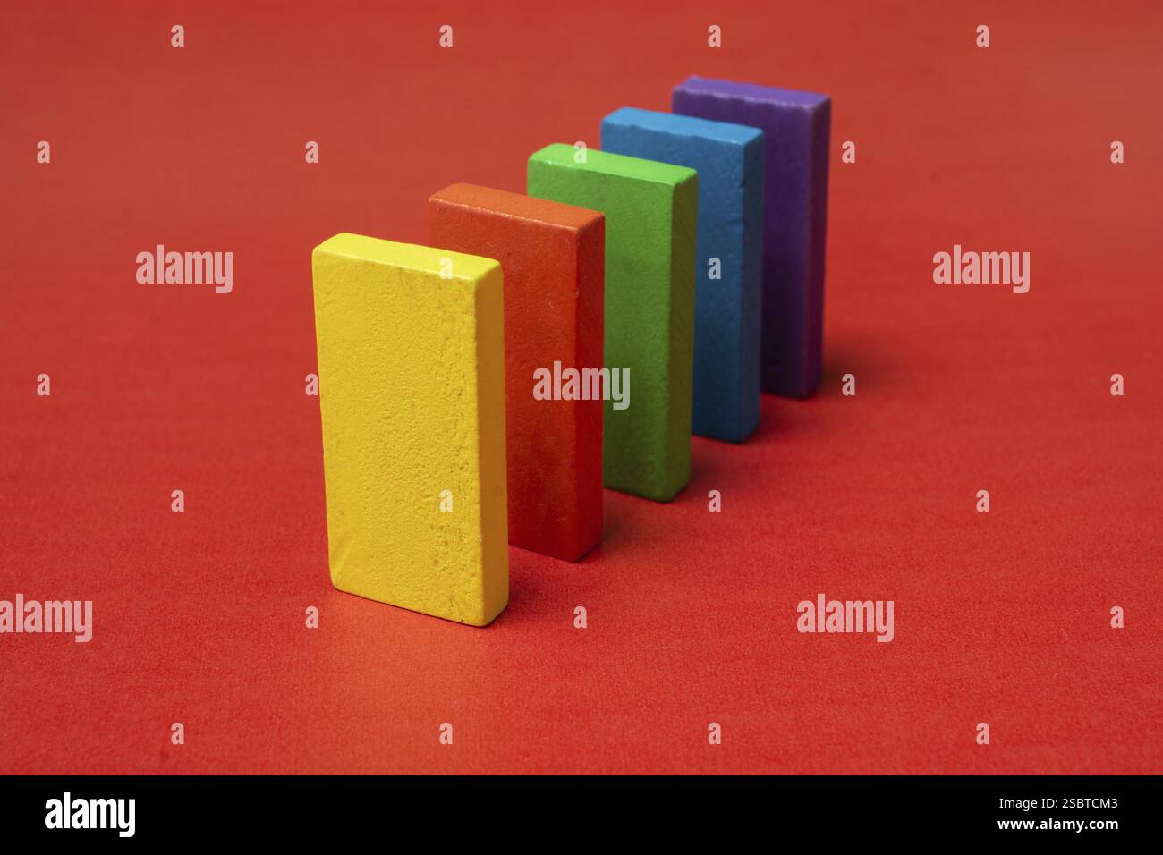 Colorful dominoes. Rainbow colored chain reaction Stock Photo - Alamy