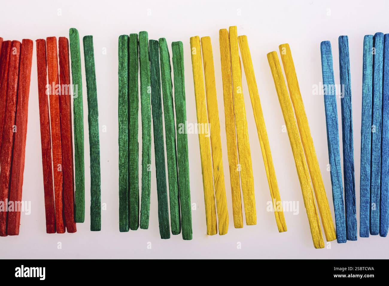 Sticks of various colors on awhite background Stock Photo - Alamy