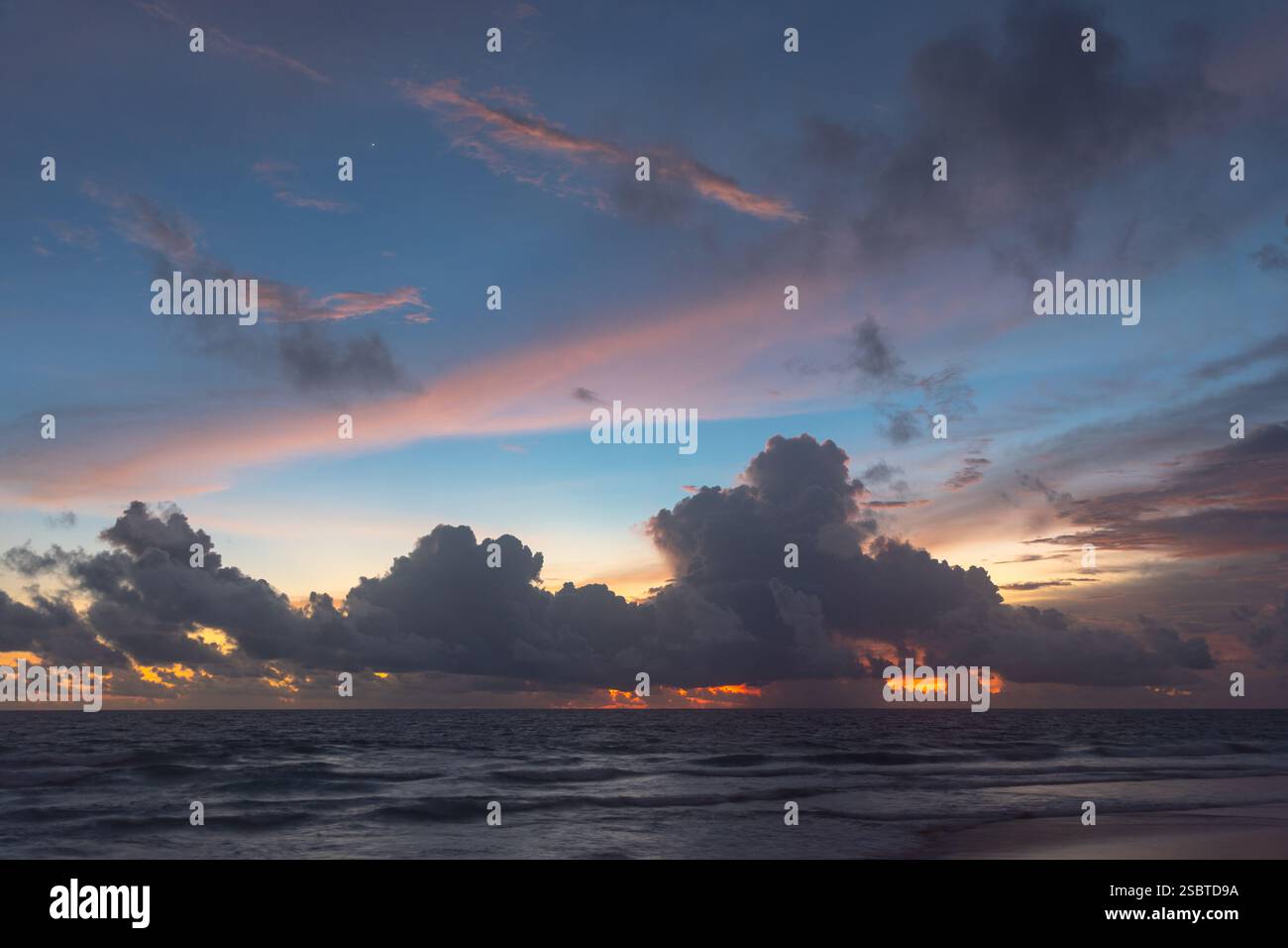 colorful light through to the cloud above the ocean. Clouds are moving ...