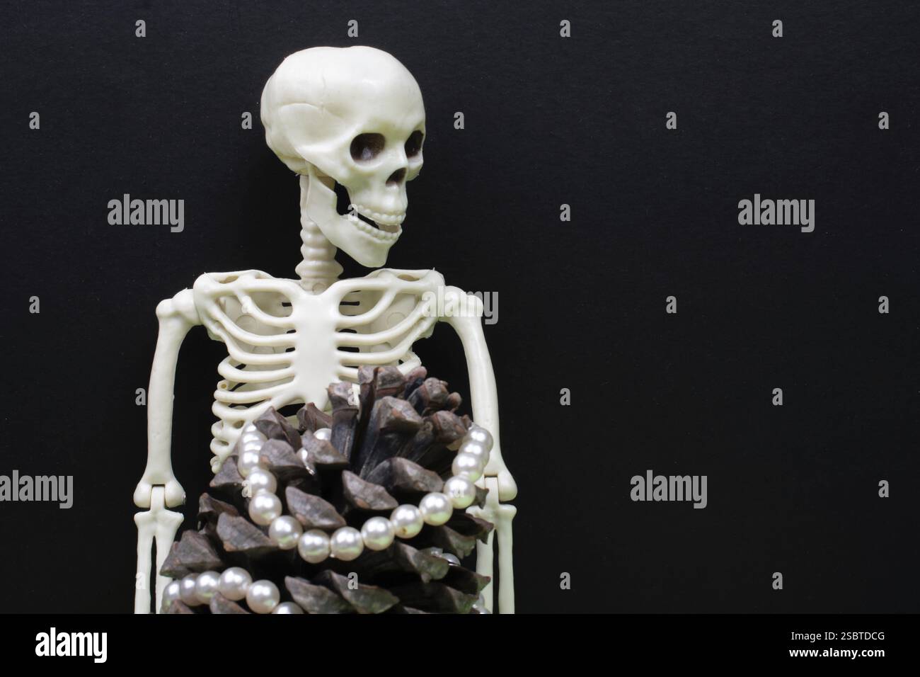 Skeleton hand pressing on man figurine on red . Death concept Stock ...