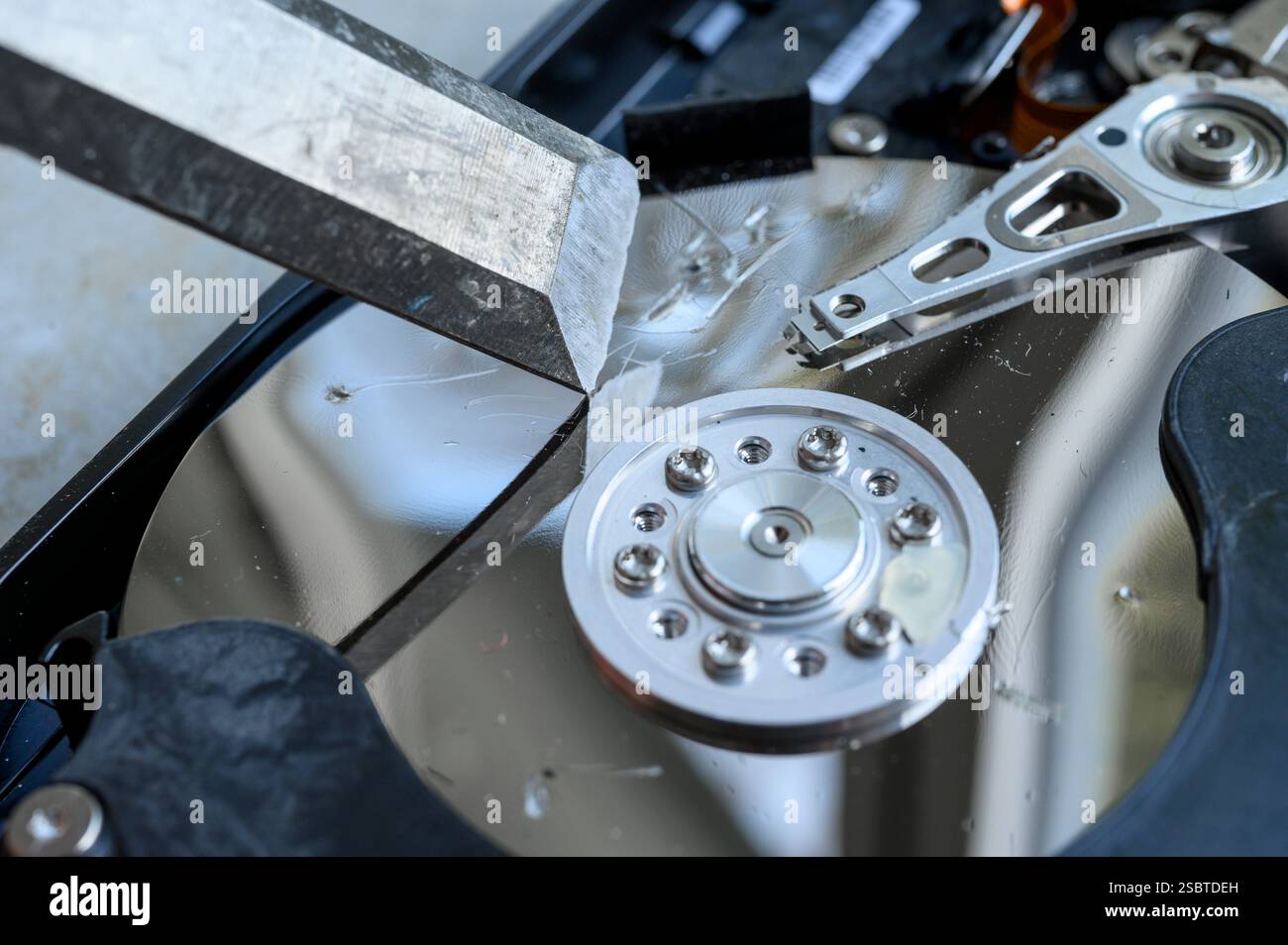 Closeup of the destruction of a computer hard drive with a chisel Stock Photo - Alamy