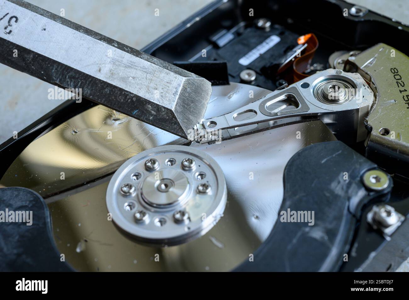 Closeup of the destruction of a computer hard drive with a chisel Stock ...