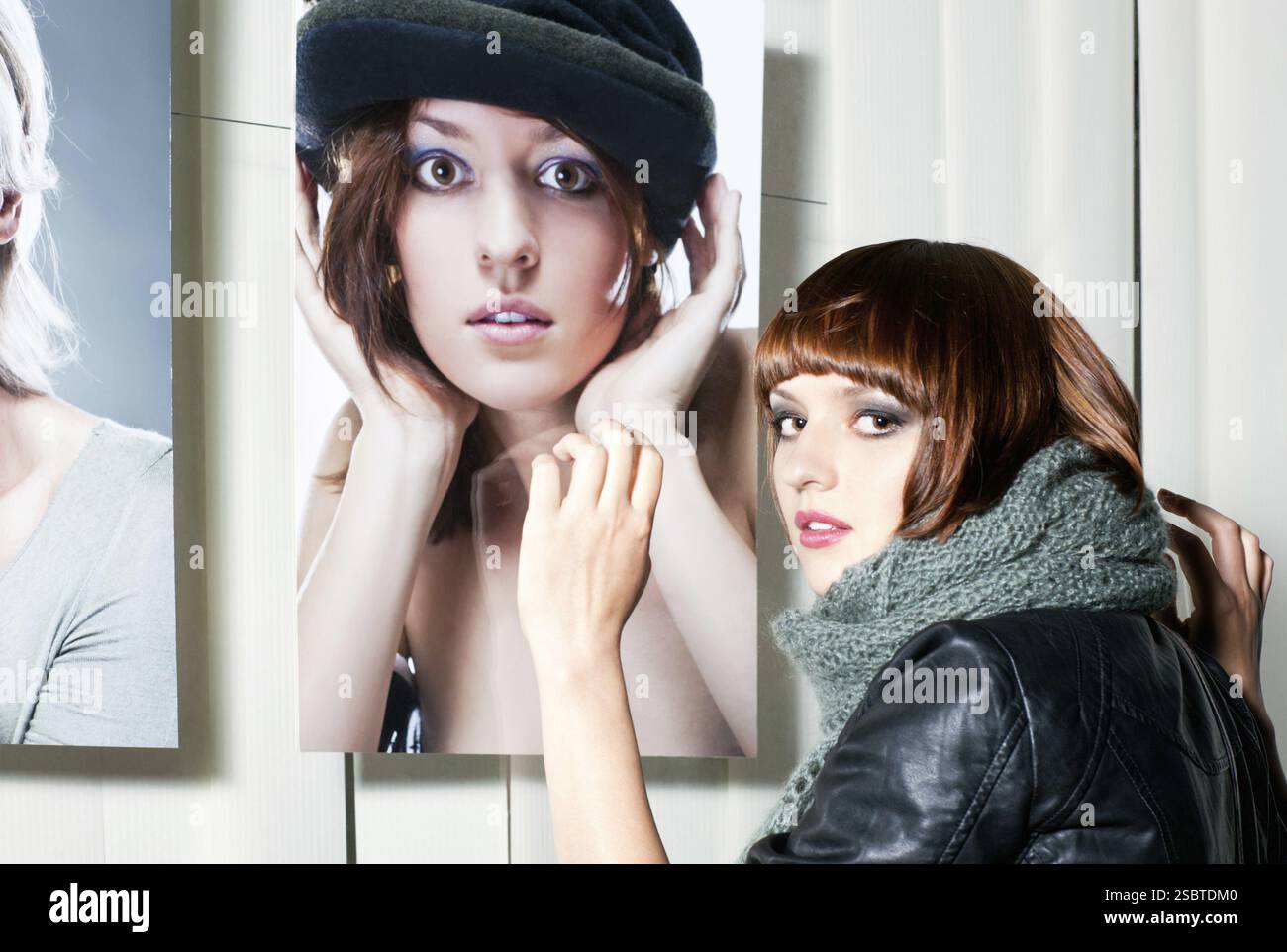 Model posing in front of a showcase with her picture Stock Photo - Alamy