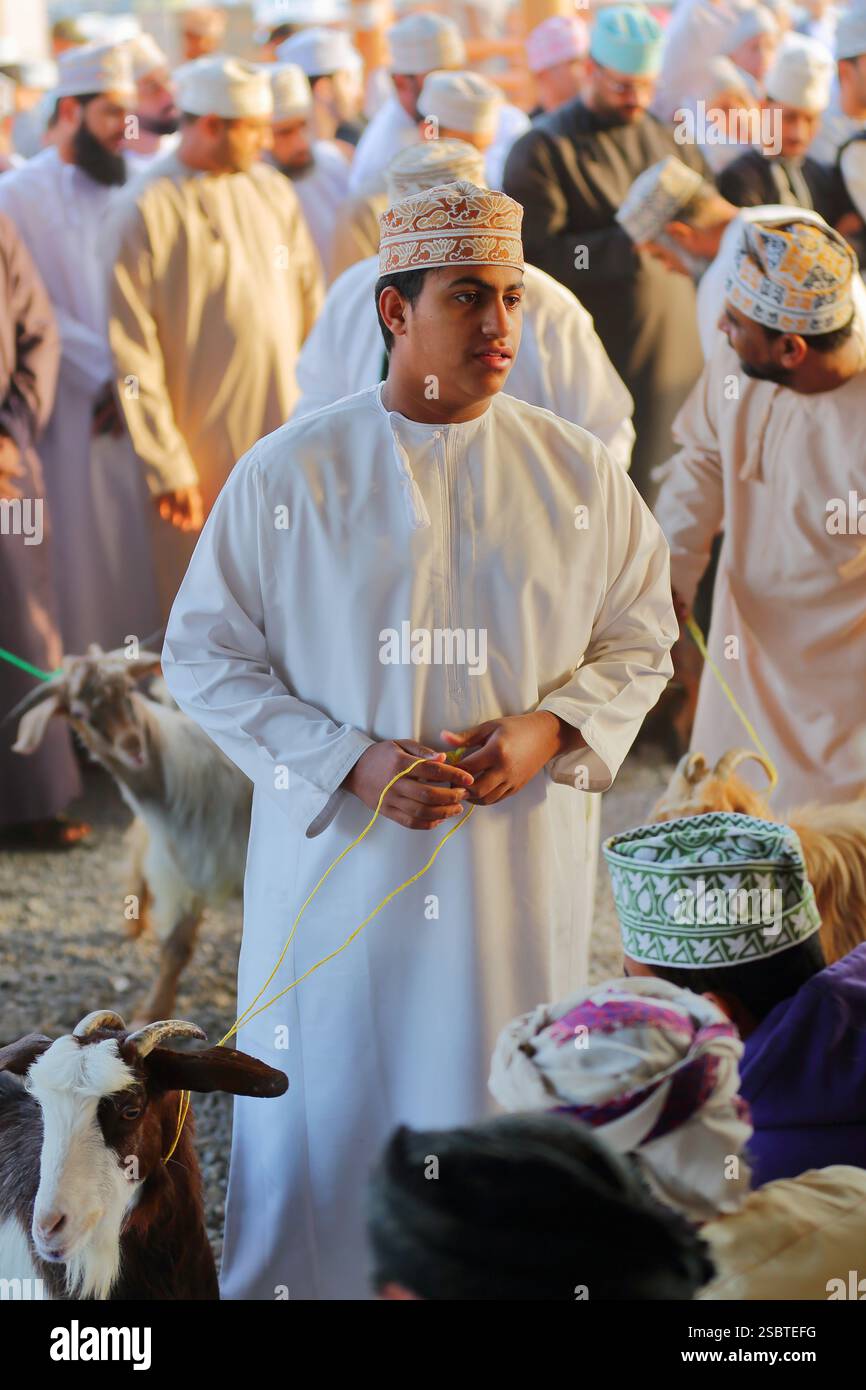 NIZWA, AL DAKHILIYAH, OMAN - DECEMBER 20, 2024: The crowded goat market ...